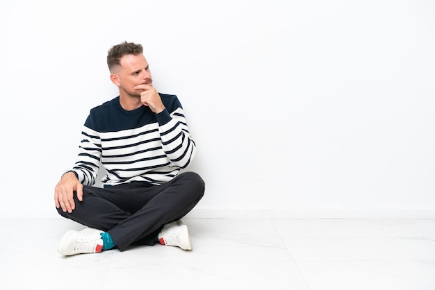 Premium Photo | Young man sitting on the floor isolated on white ... Premium Photo | Young man sitting on the floor isolated on white ...