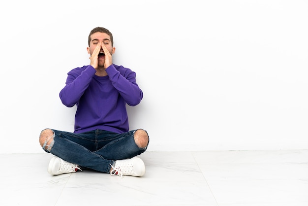 Premium Photo | Young man sitting on the floor shouting and announcing ... Premium Photo | Young man sitting on the floor shouting and announcing ...