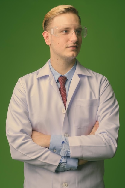 Premium Photo | Young man standing against white background Premium Photo | Young man standing against white background