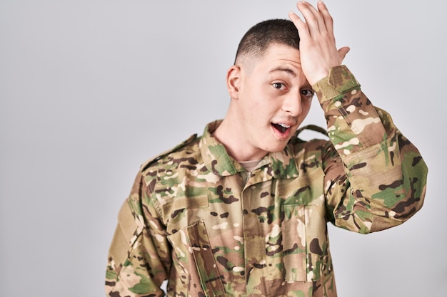 Premium Photo Young Man Wearing Camouflage Army Uniform Surprised With Hand On Head For