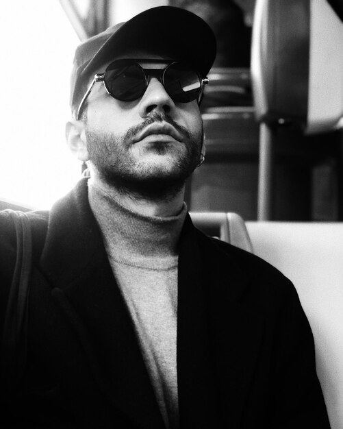 Premium Photo Young Man Wearing Cap And Sunglasses At Home