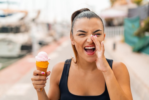 Premium Photo Young Pretty Woman With A Cornet Ice Cream At Outdoors Shouting With Mouth Wide Open