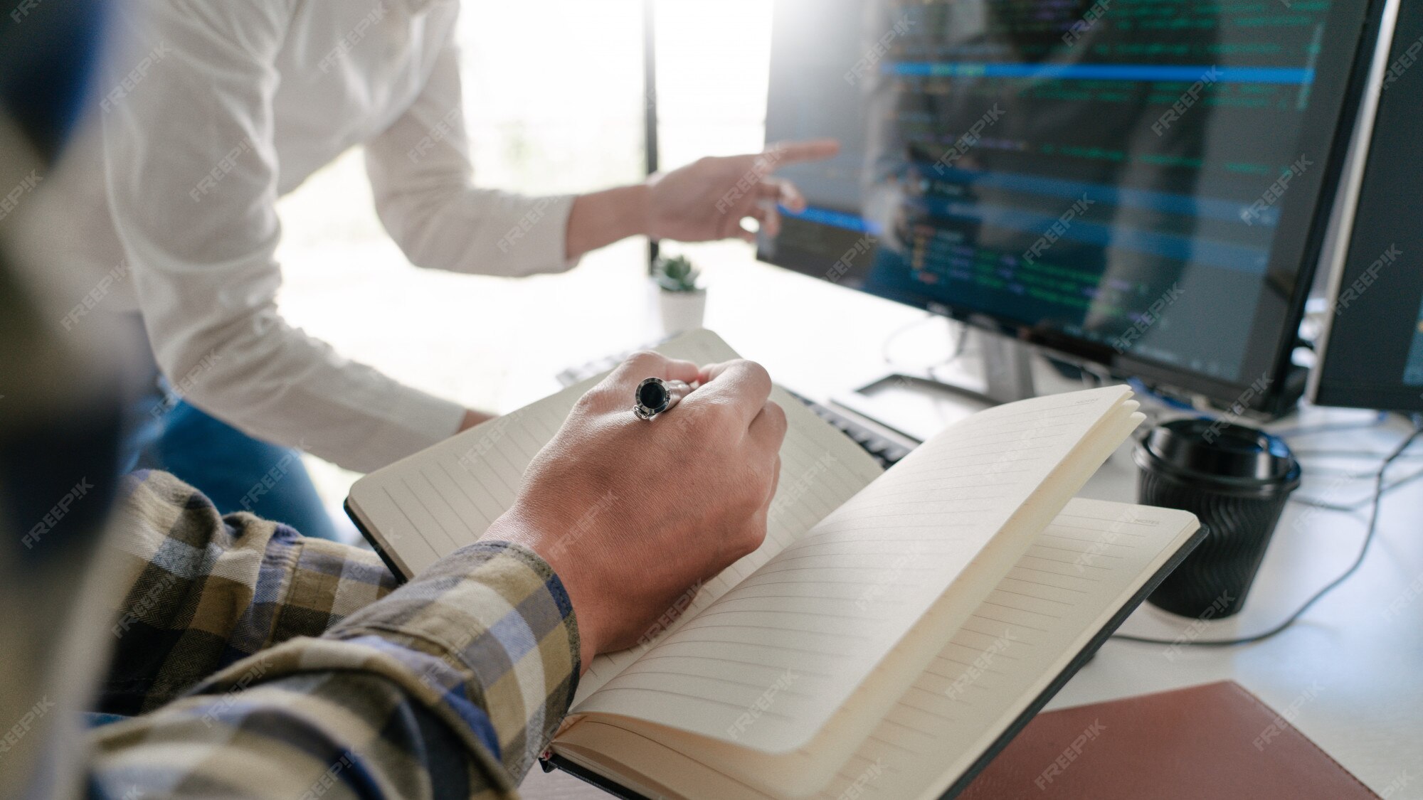 Premium Photo | Young startup programmers sitting at desks working on ...