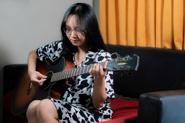 Premium Photo | Young woman playing acoustic guitar Premium Photo | Young woman playing acoustic guitar