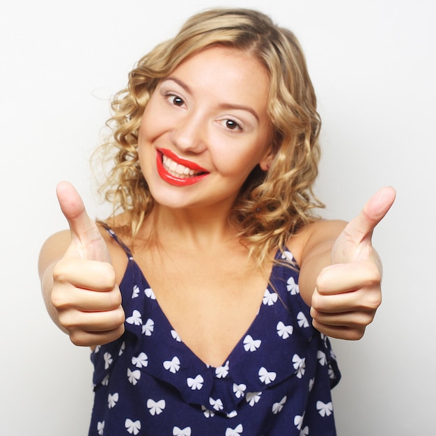 Premium Photo | Young woman showing thumbs up gesture Premium Photo | Young woman showing thumbs up gesture