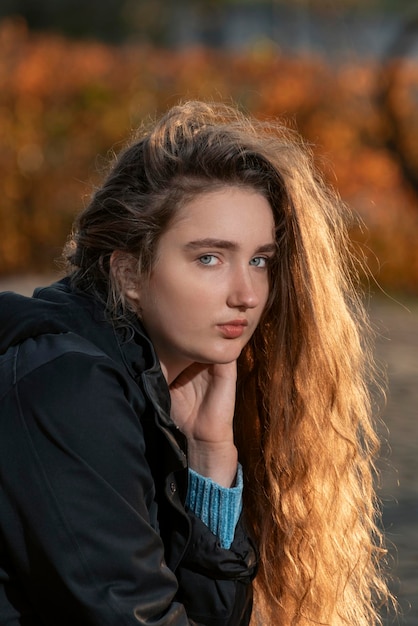 Premium Photo Young Woman With Long Chestnut Thick Curly Hair Looks Into The Camera Girl With