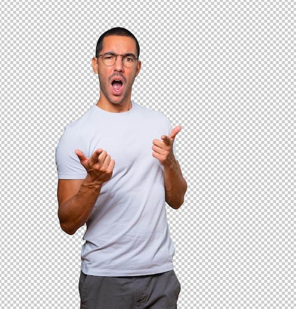 Premium PSD | Amazed young man pointing at you with his finger Premium PSD | Amazed young man pointing at you with his finger
